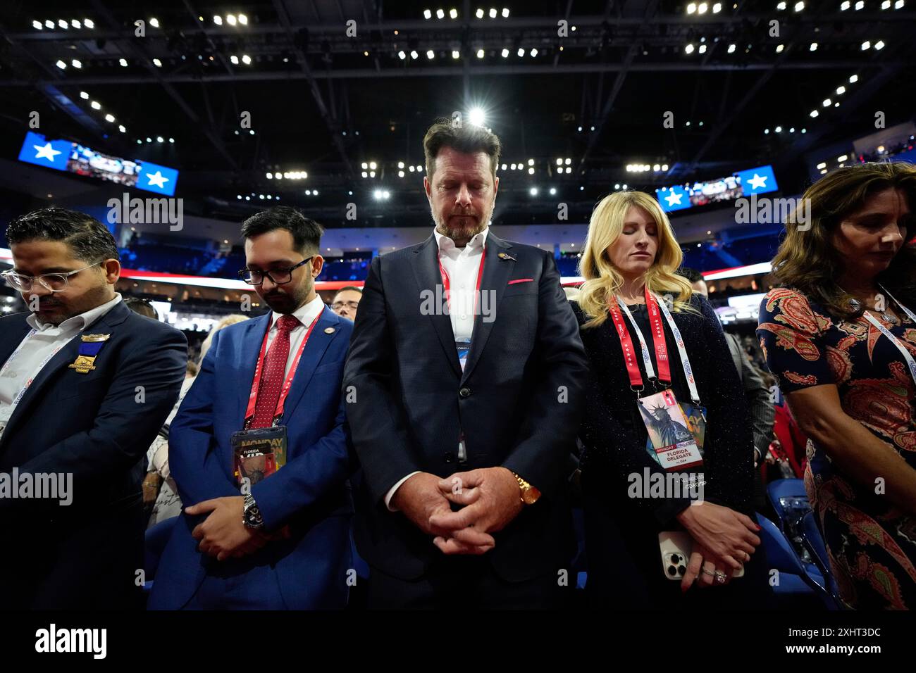 Florida delegates pray during the Republican National Convention Monday ...