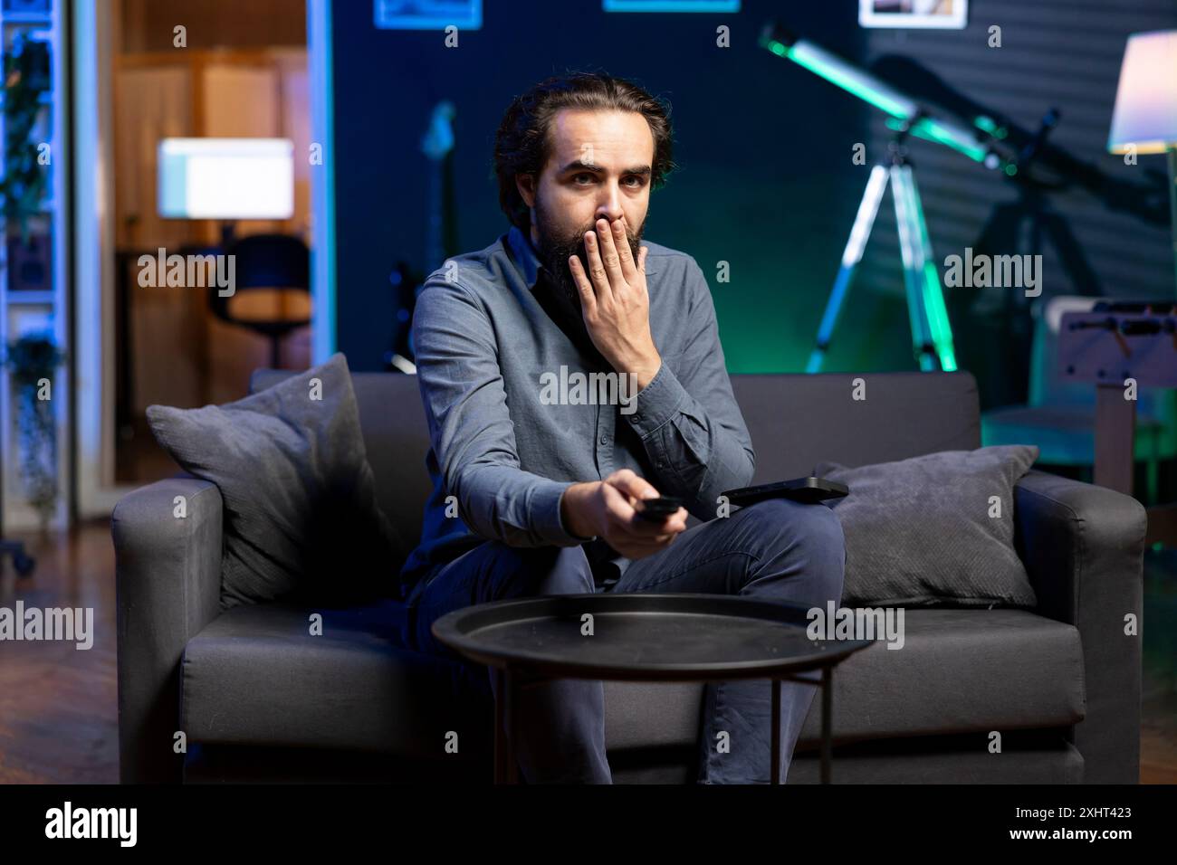 Man gasping while watching horror movie on streaming service, enjoying ...