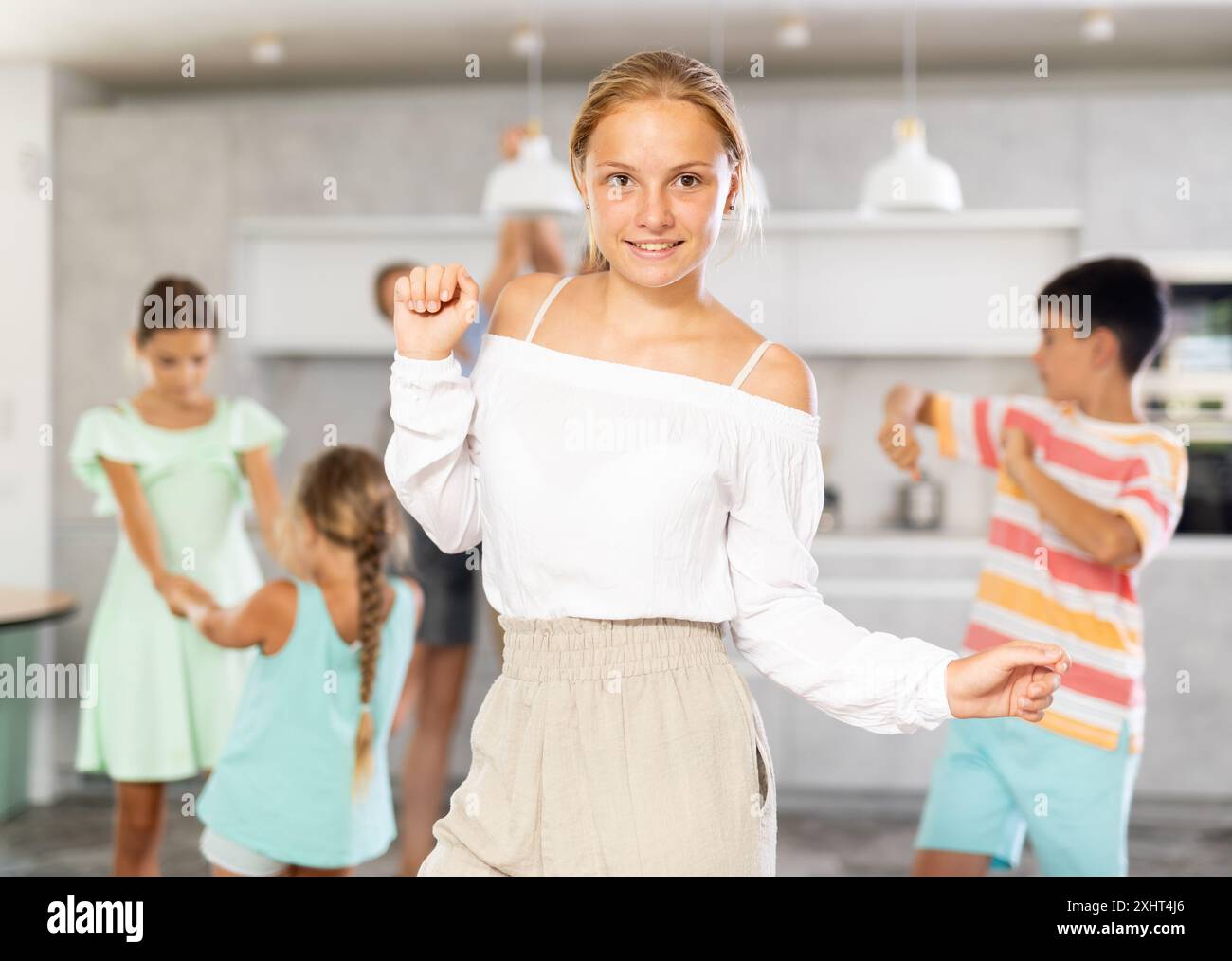 Behind cheerful girl, big family of parents, sisters, brother is ...