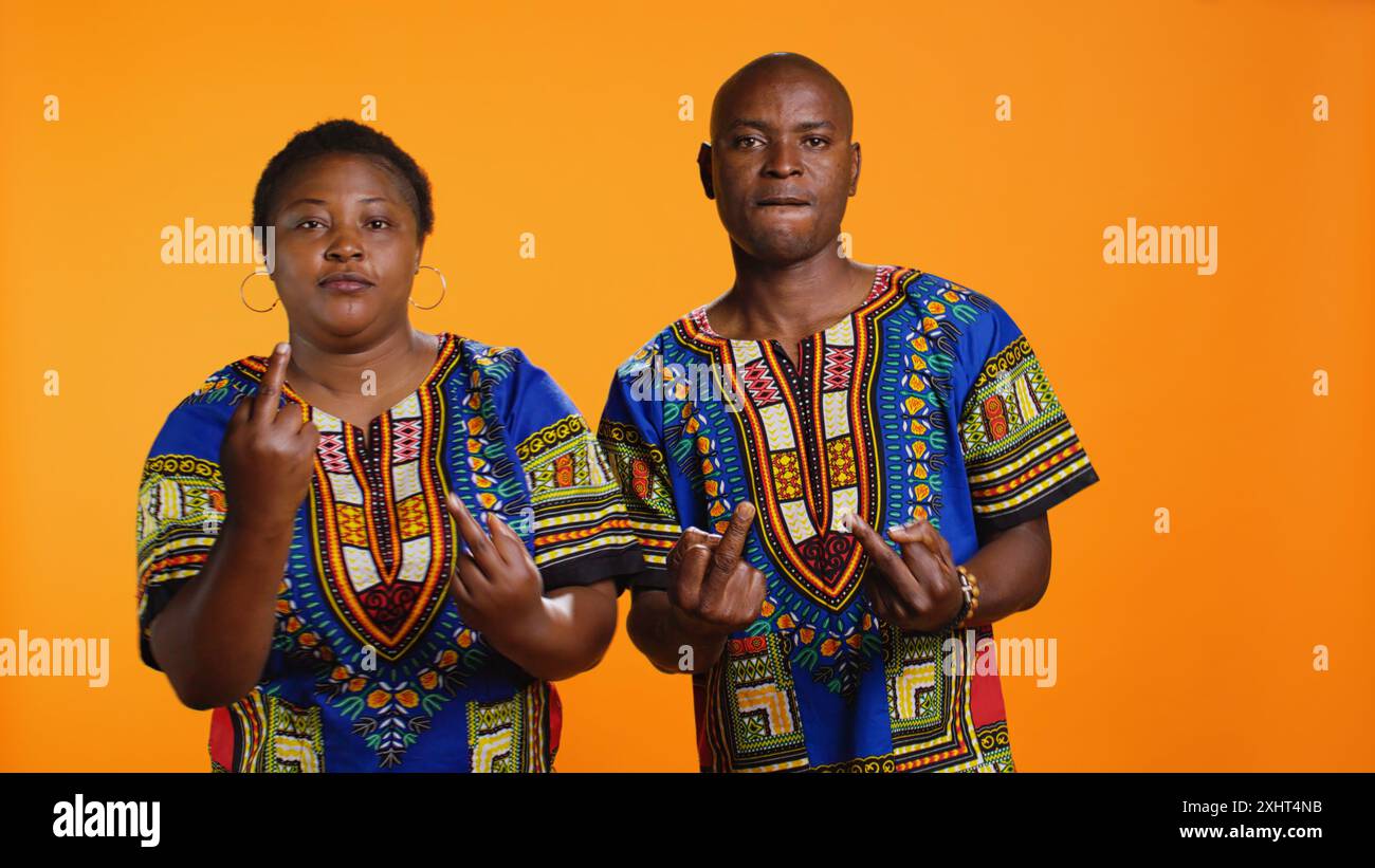 Provocative ethnic couple show middle finger on camera, doing offensive ...