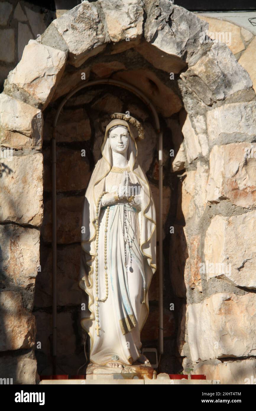 A statue of Madonna on a street in Italy Stock Photo - Alamy