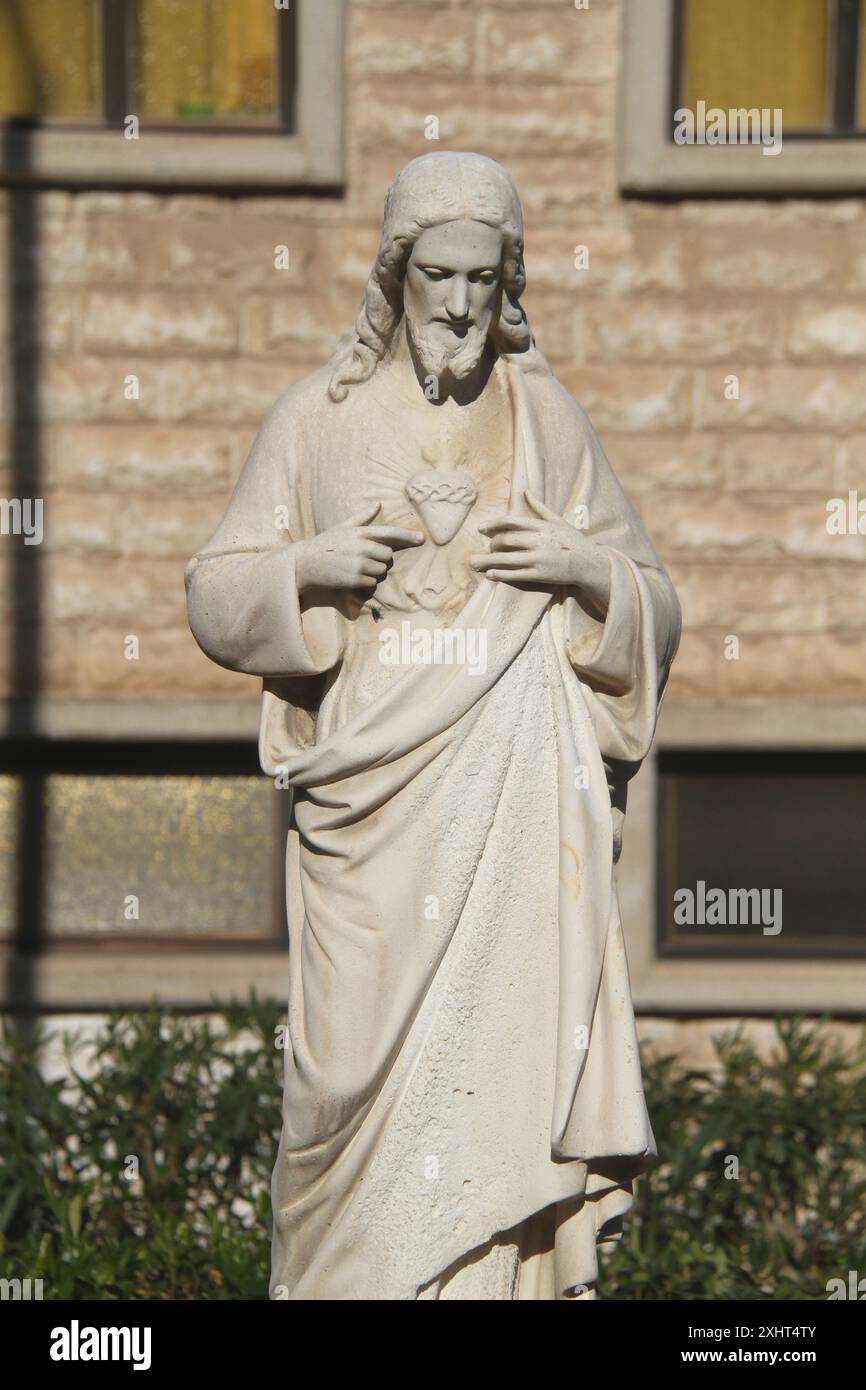 A Sacred Heart of Jesus statue on a street in Italy Stock Photo - Alamy