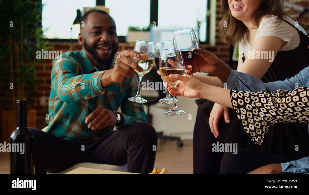 Multiethnic coworkers celebrating business success at work, gathered at ...