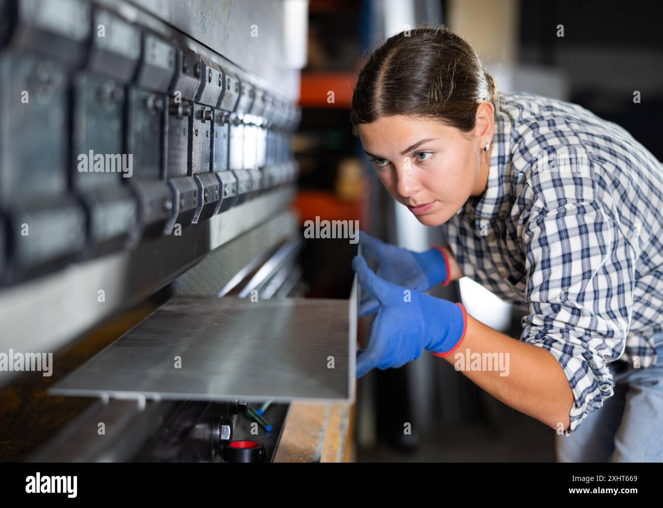 Female worker operating metal press brake in workshop Stock Photo - Alamy