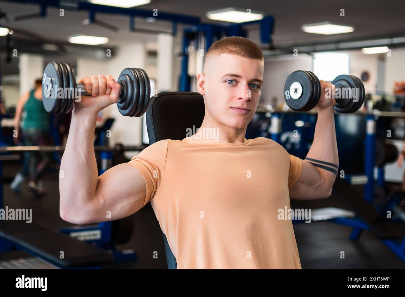 Man athlete trains dumbbells in hi-res stock photography and images - Alamy