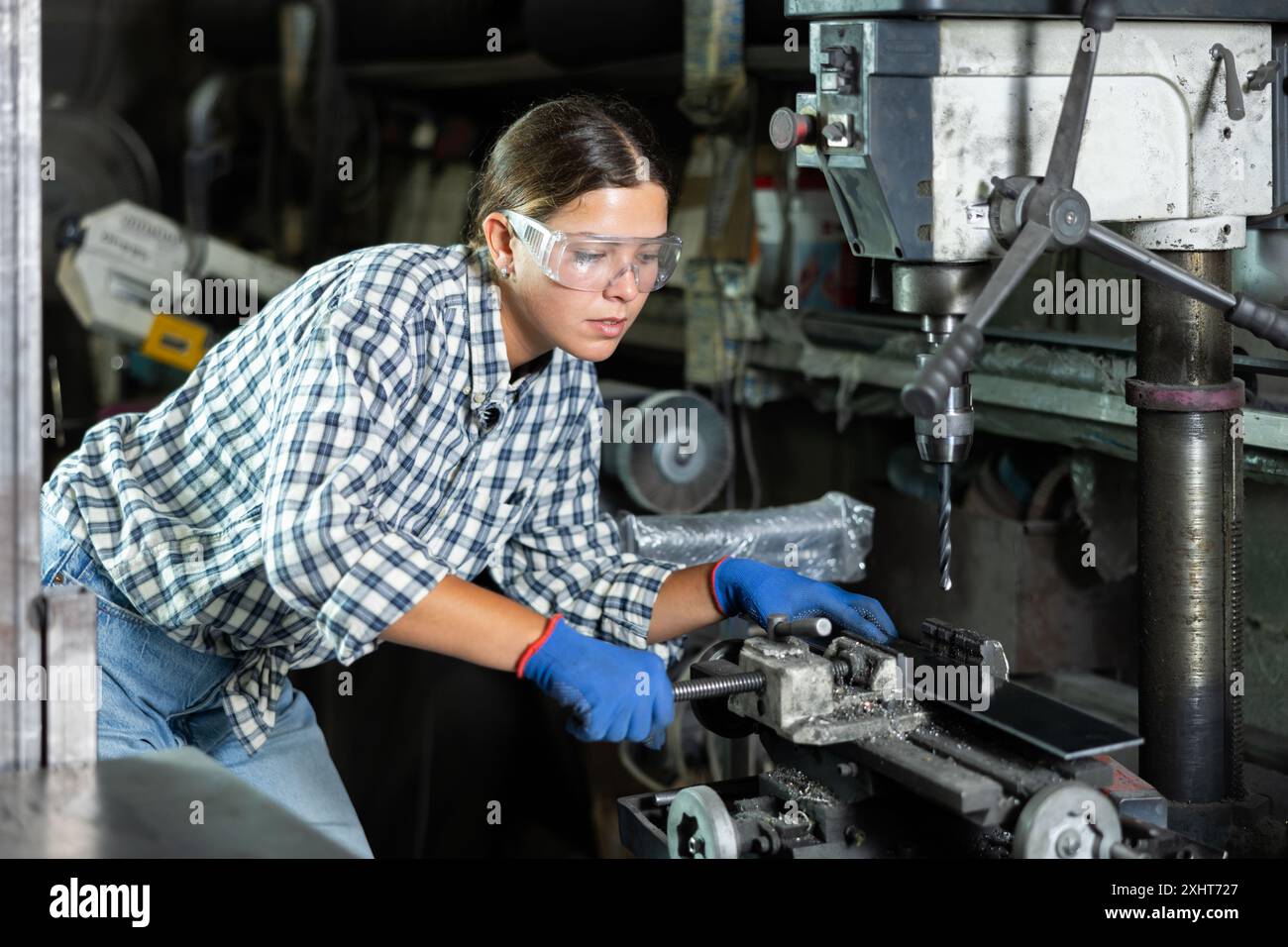Young woman working with drill machine Stock Photo - Alamy