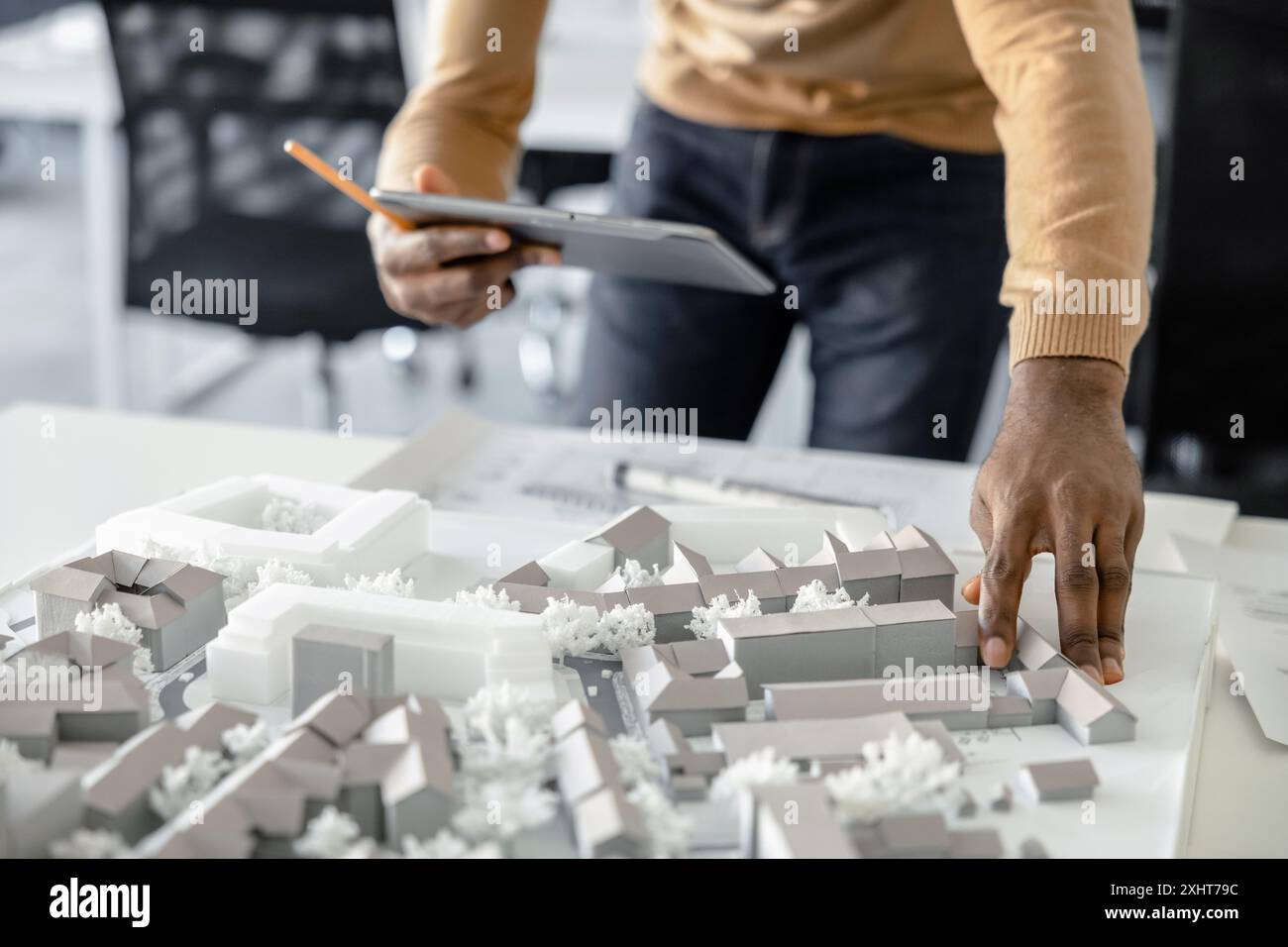 Skillful man architect solving engineers tasks in his modern workplace ...