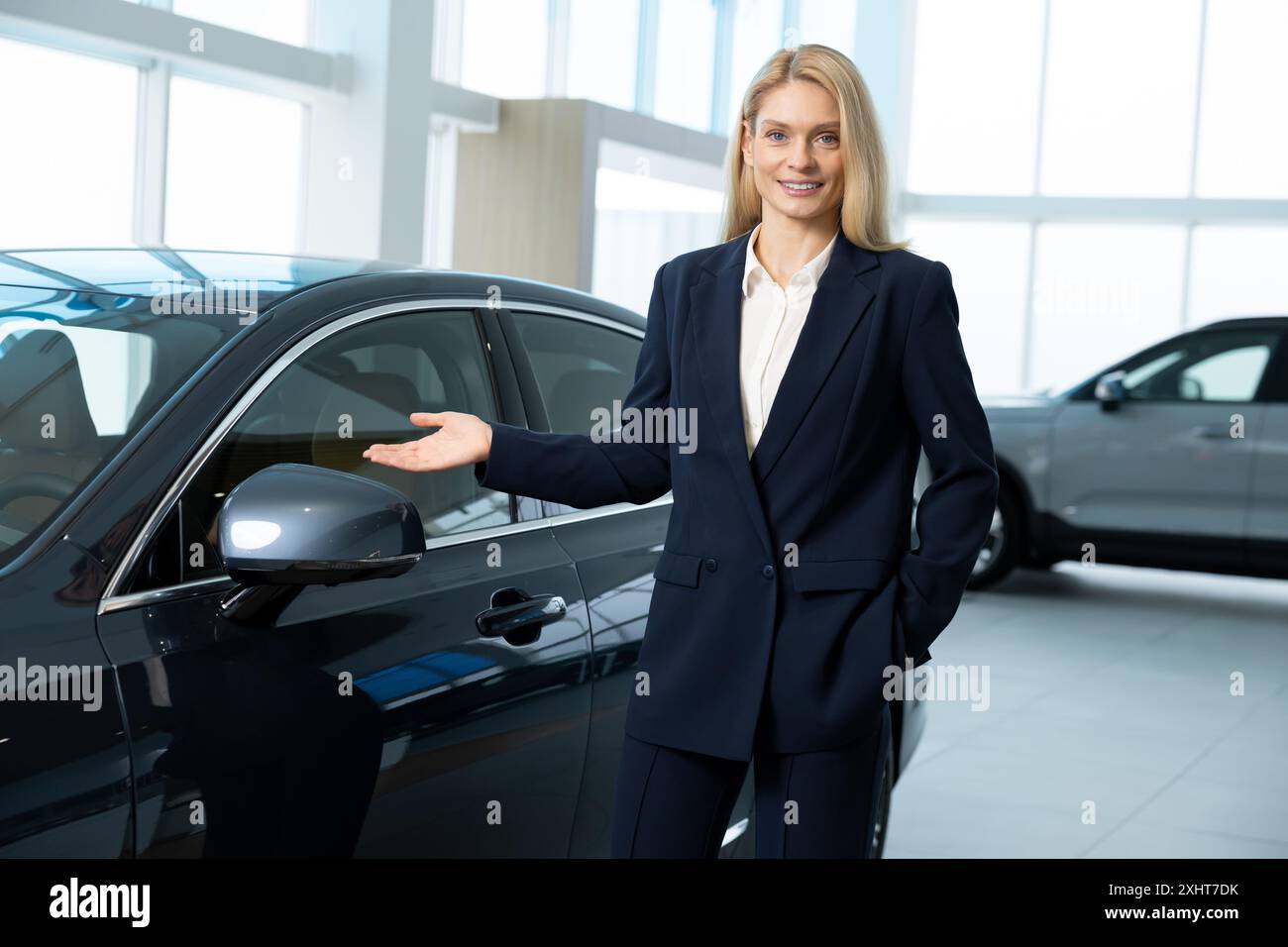 Female sale assistant in elegant suit in a car showroom Stock Photo - Alamy