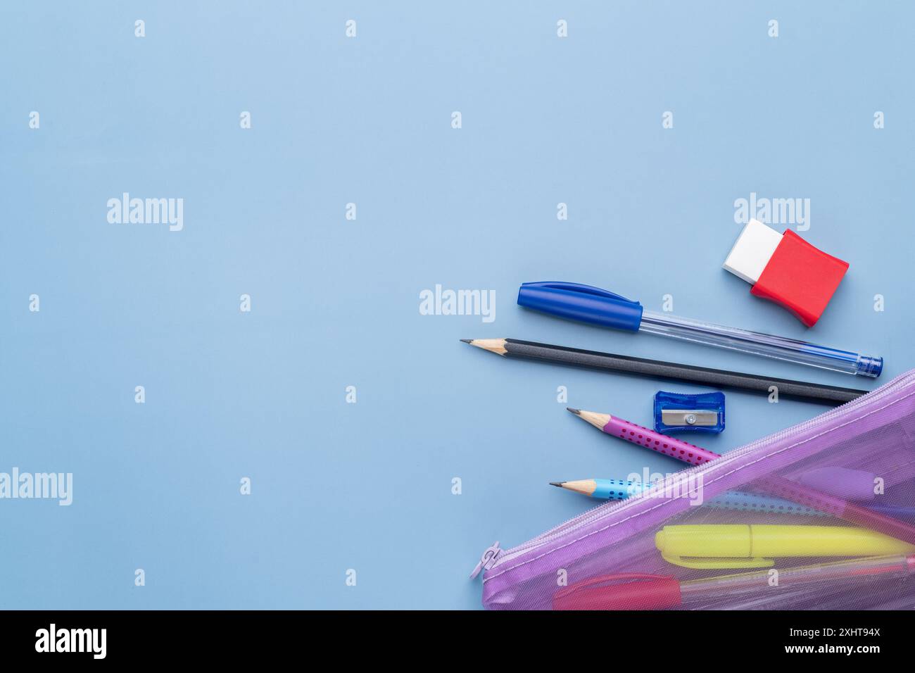 Back to school backdrop. School supply over light blue background with ...