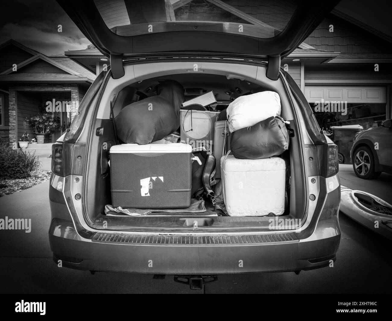 Full van packed for a camping trip with the back open Stock Photo - Alamy