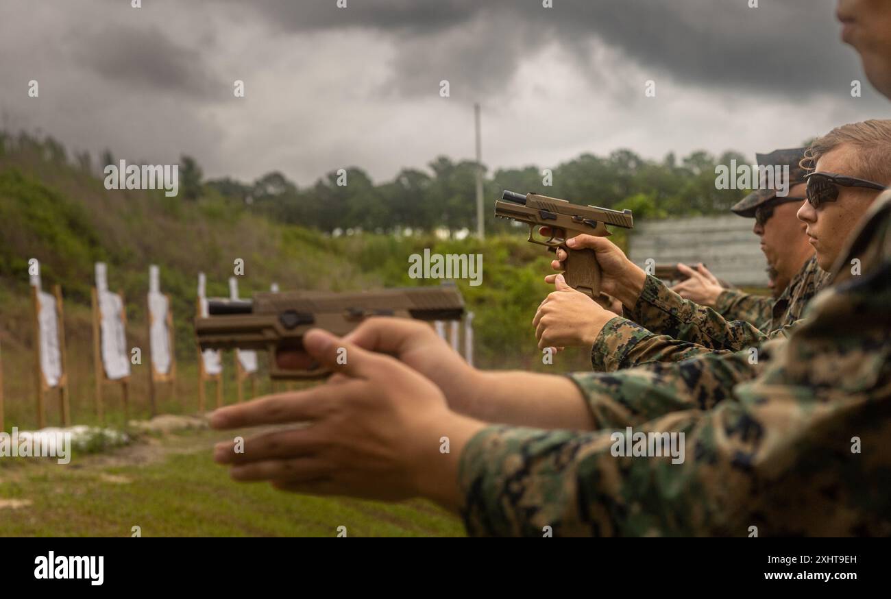 U.S. Marines speed reload their M18 service pistol during a live-fire ...