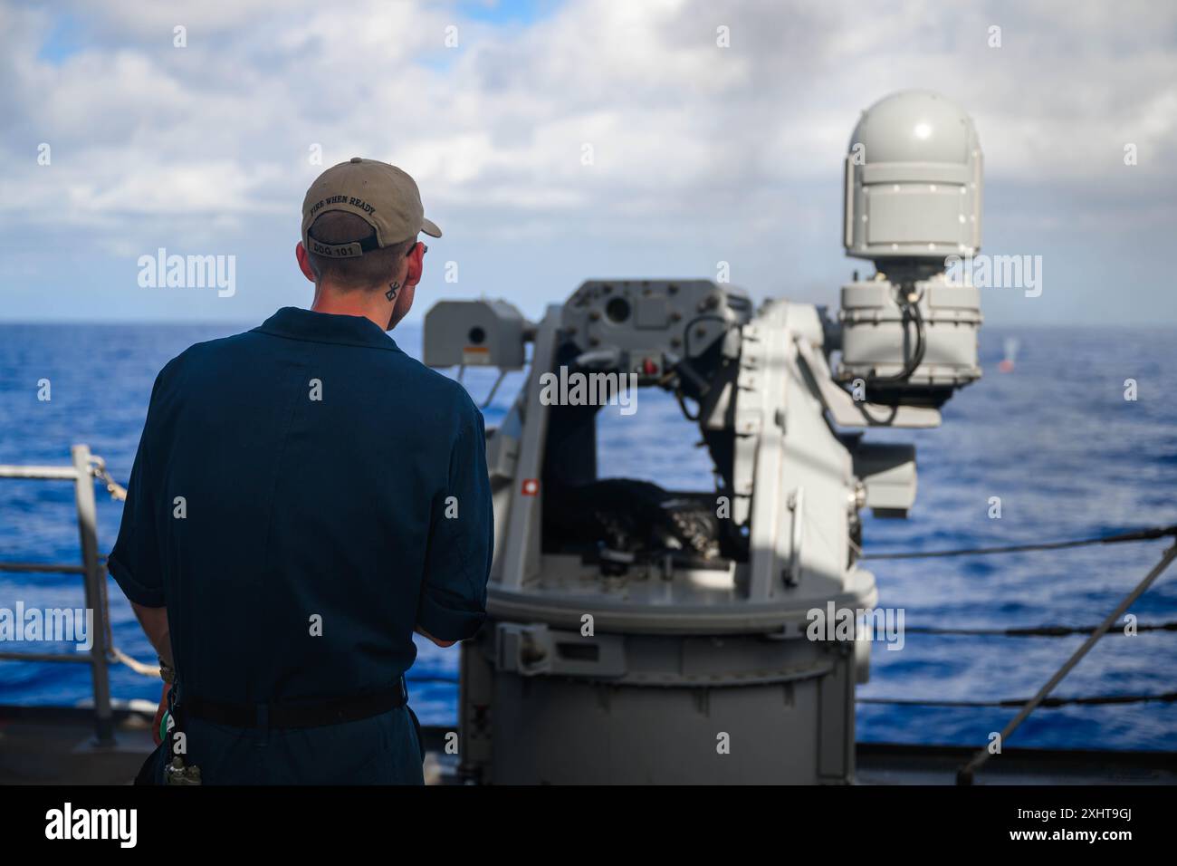 Gunner’s Mate 2nd Class Cameron Donahue observes as an MK-38 25mm ...