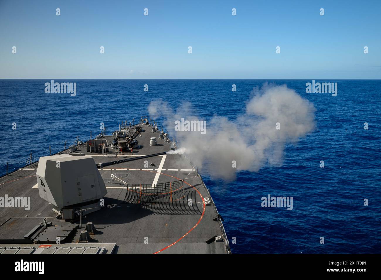 A Mark 45 5-inch gun fires aboard the Arleigh Burke-class guided ...