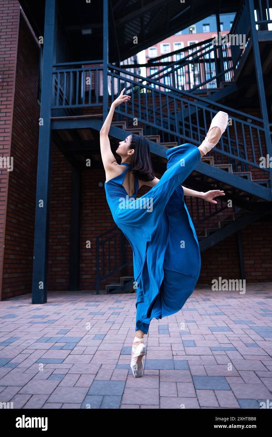 Beautiful Asian ballerina dancing outdoors. Urban landscape Stock Photo - Alamy