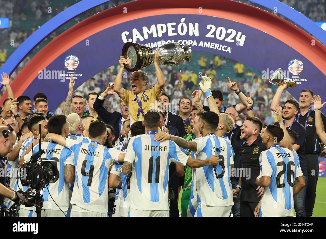Argentinas staff member Mario Di Stefano celebrates lifts the trophy ...