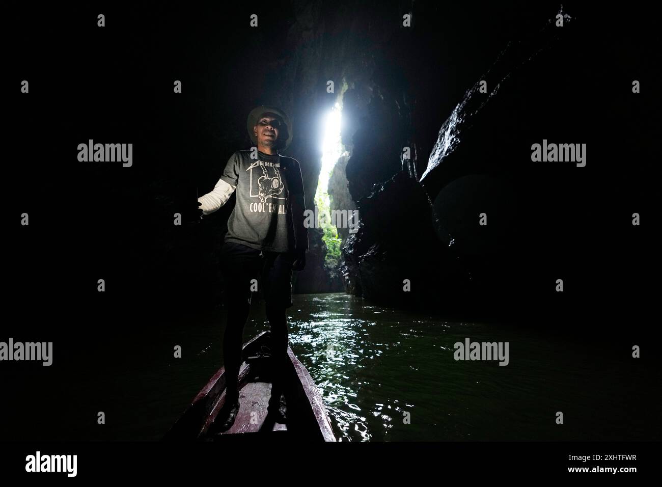 A local guide stands on his boat in Bokimaruru Cave in Central ...