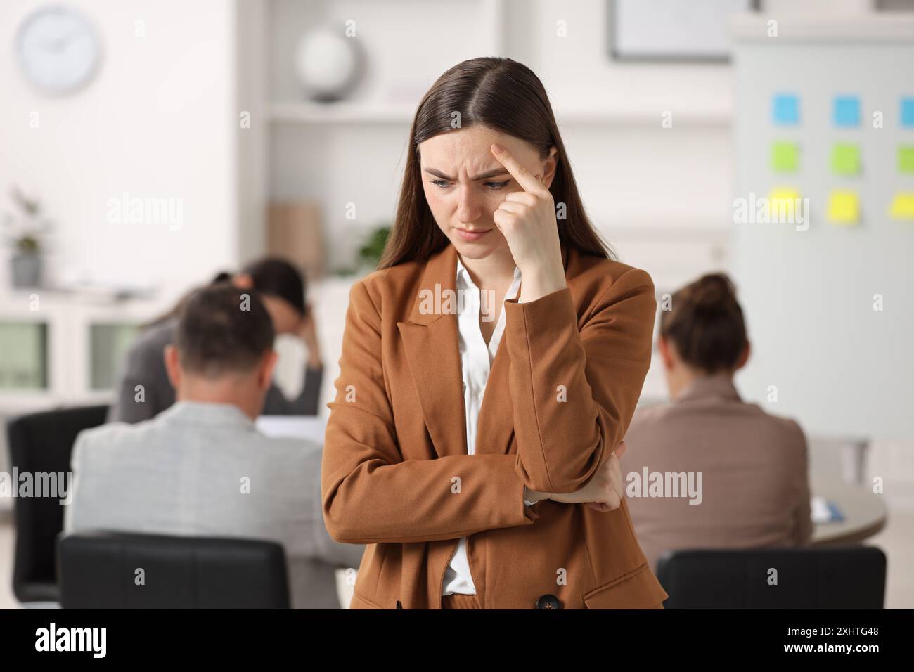 Woman feeling embarrassed during business meeting in office Stock Photo ...