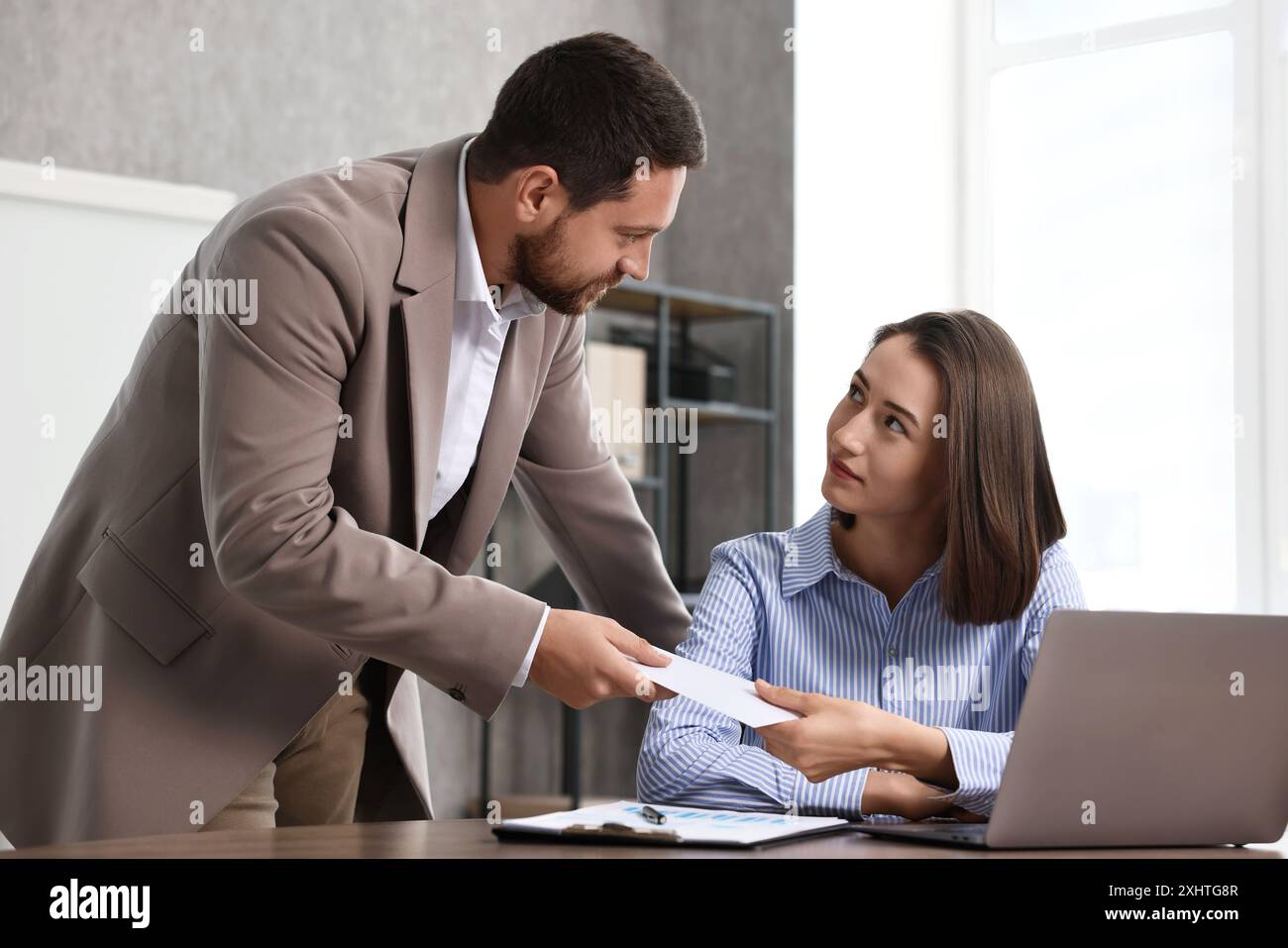 Employer giving female worker in hi-res stock photography and images ...