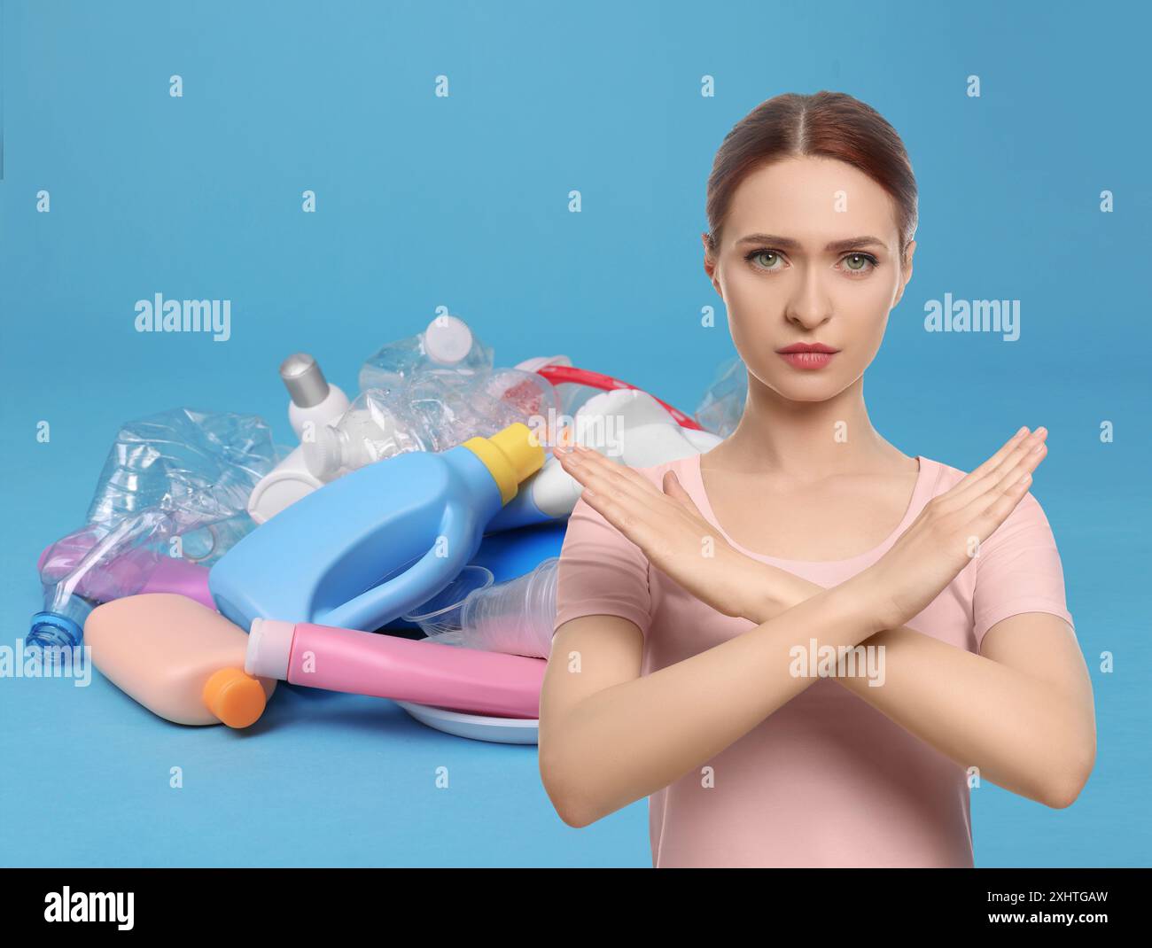 Environmental pollution. Woman showing stop gesture, heap of garbage on ...