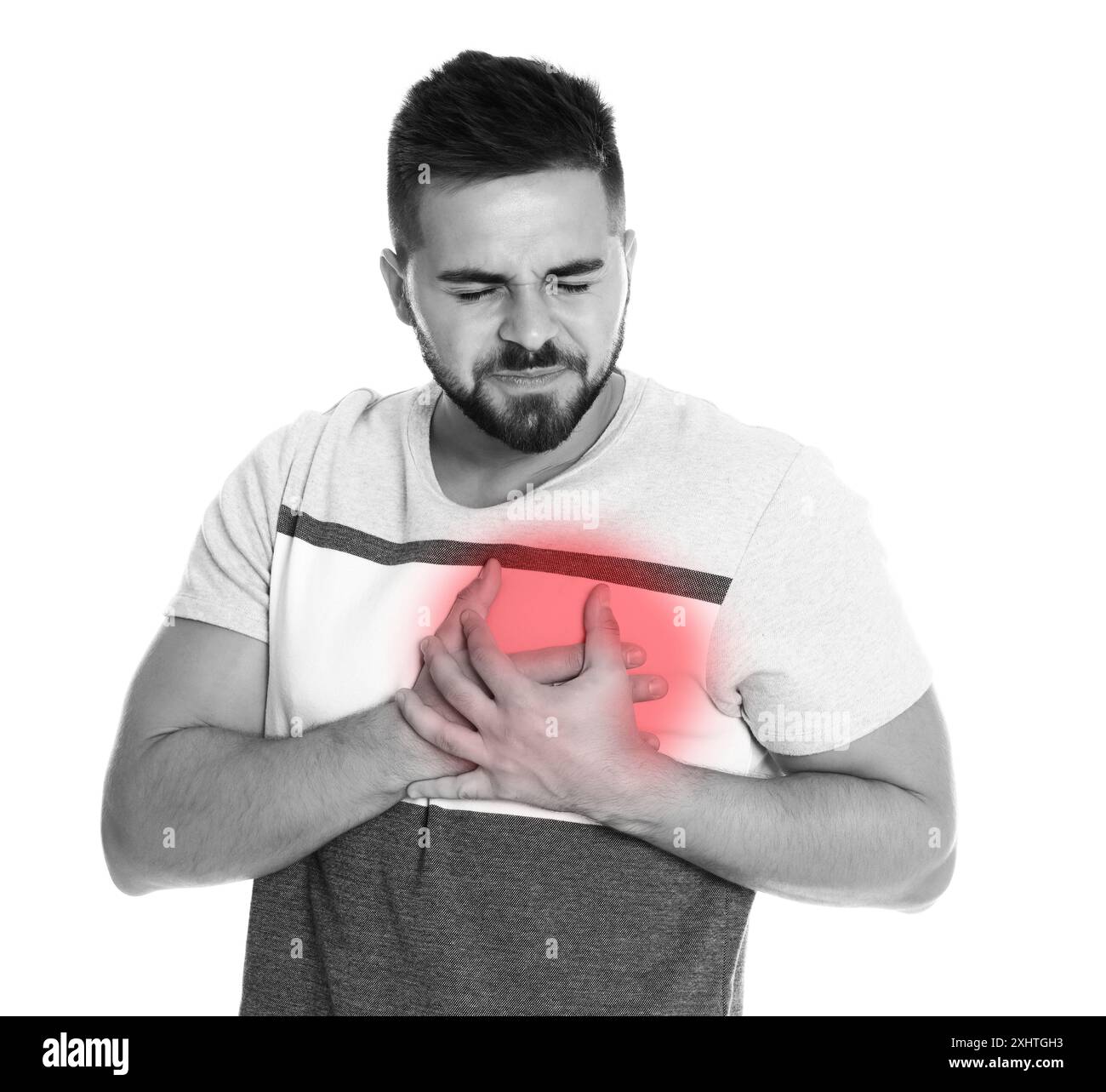 Heart attack. Young man suffering from pain and pressing hands to chest ...