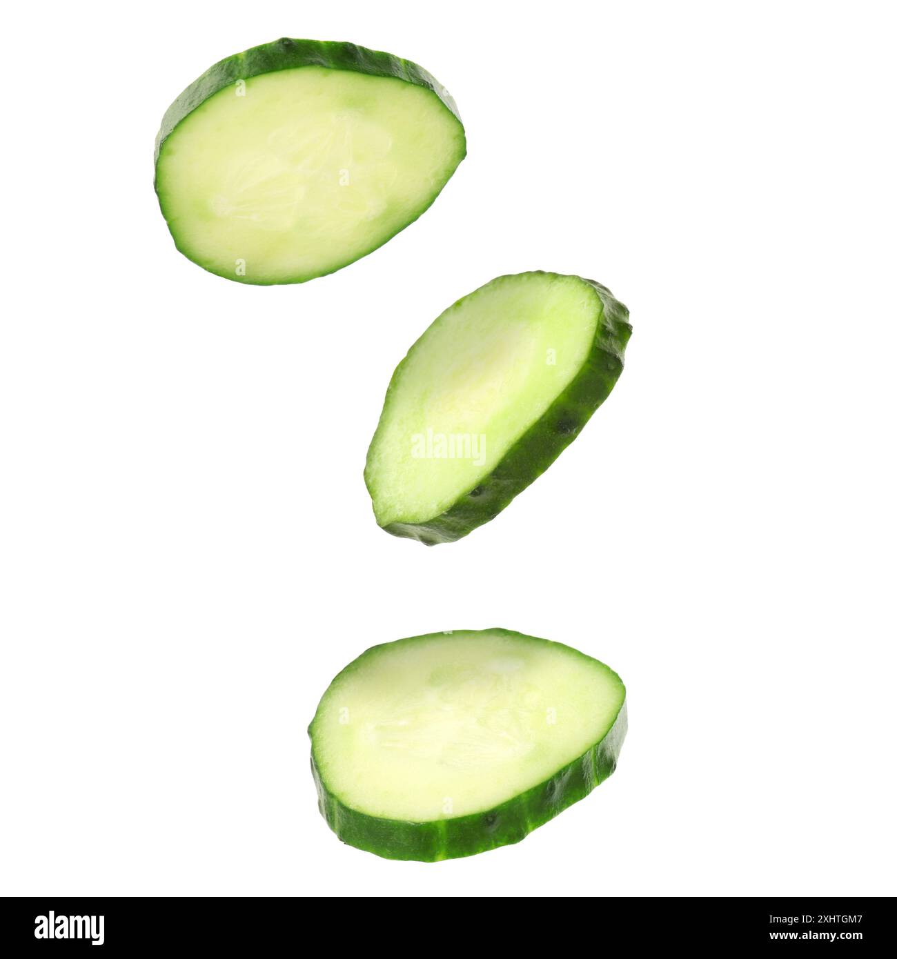 Fresh cucumber slices in air on white background Stock Photo - Alamy