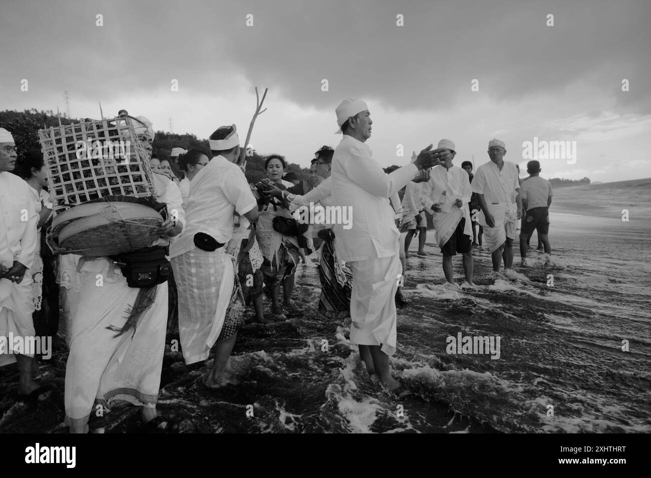 Purifying the spirits: A priest leading the members of a Balinese ...