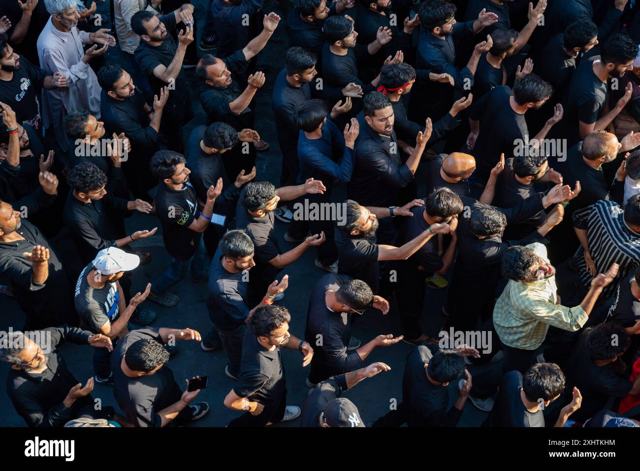 Kashmiri Shia Muslim mourners, holding religious flags, beat their ...