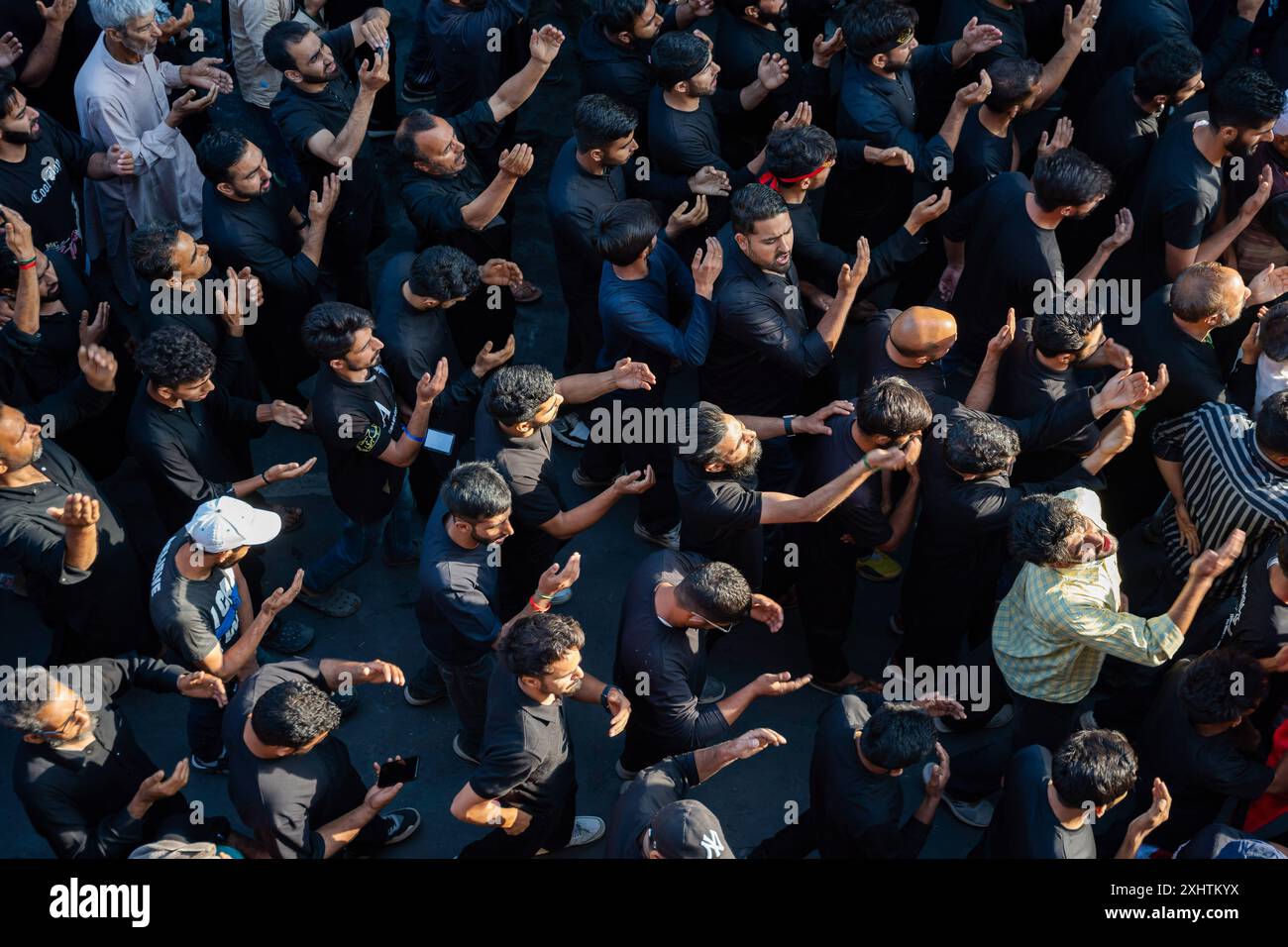 Kashmiri Shia Muslim mourners, holding religious flags, beat their ...