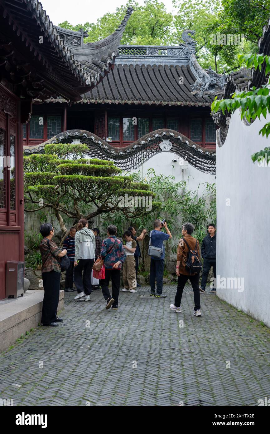 Shanghai, China - June 06, 2024 : A group of people walk on a brick ...