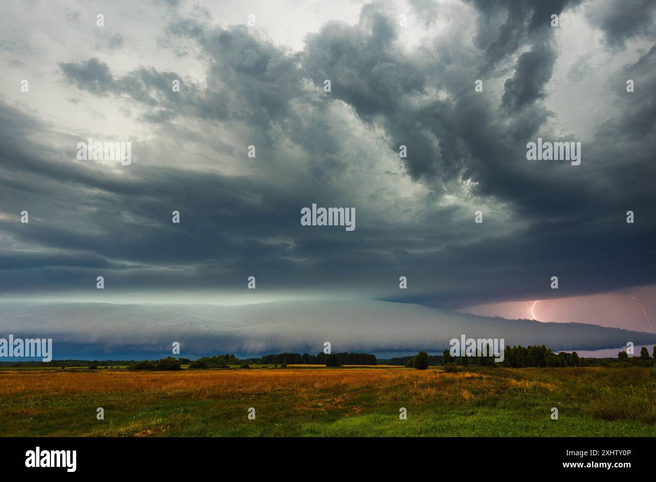 Supercell cloud with distant lightning illuminating the storm structure ...