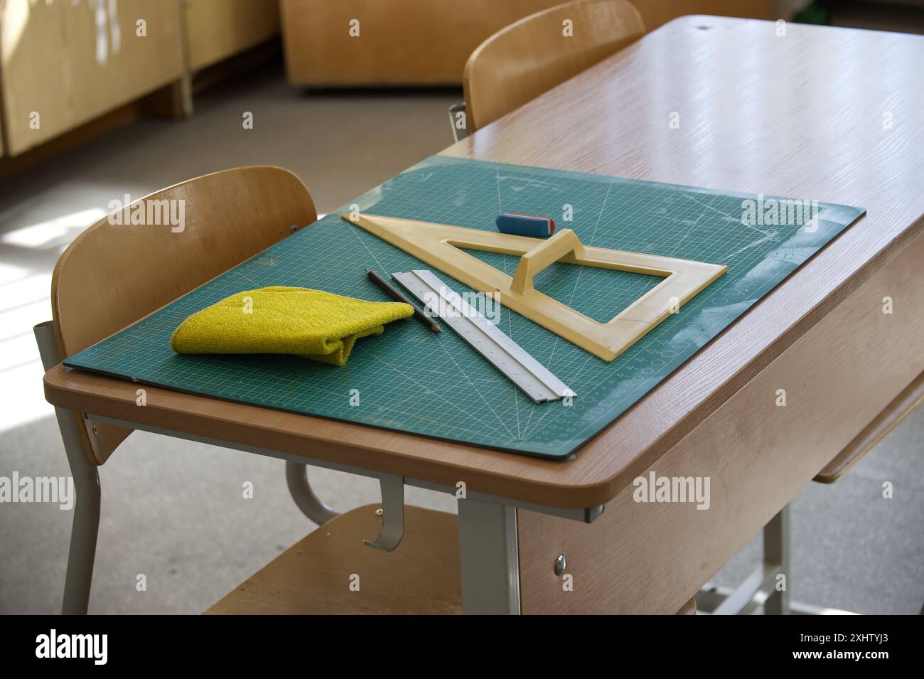 Classroom desk arranged with mathematical instruments like a ruler and ...