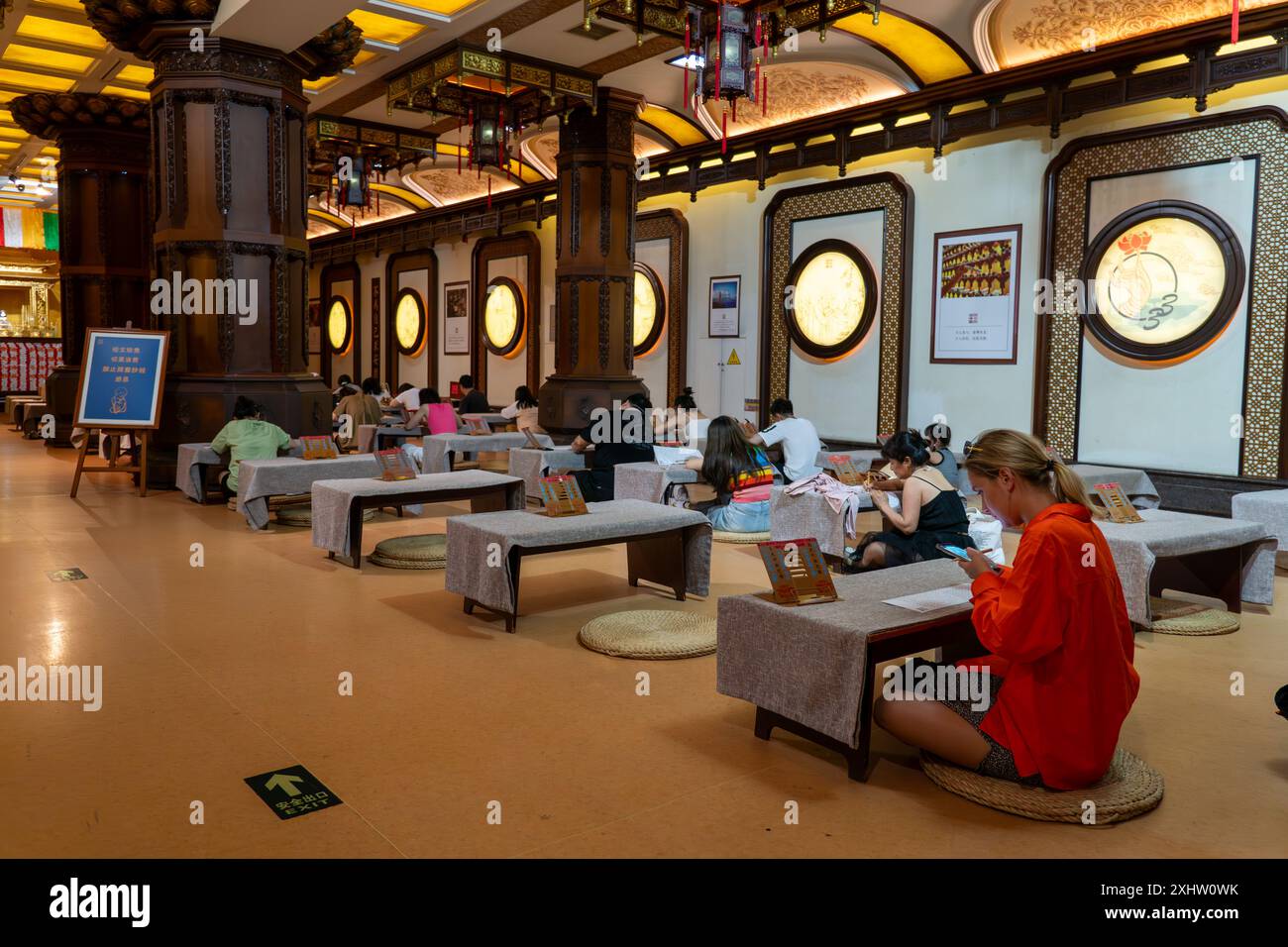 tourists in a Chinese Buddhist temple write wishes. Nanshan Cultural ...