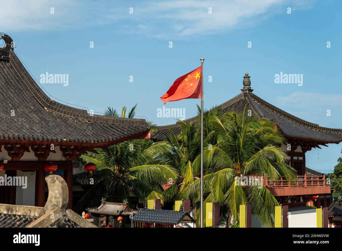 A flag is flying over a Buddhist temple. Nanshan Cultural Tourism Zone ...