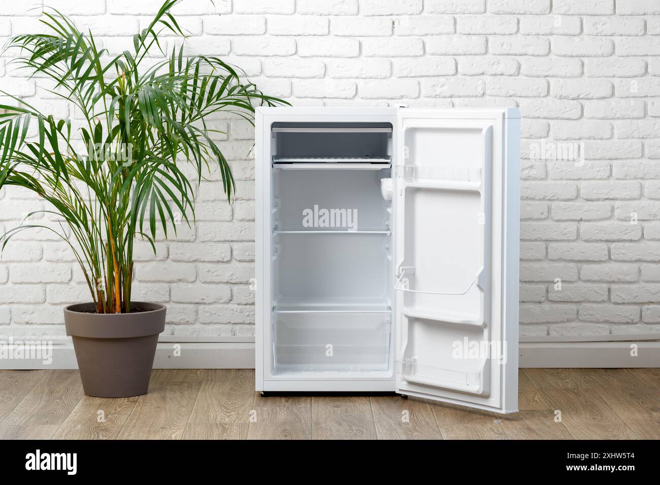 White Refrigerator With Open Door in Front of Brick Wall Stock Photo ...