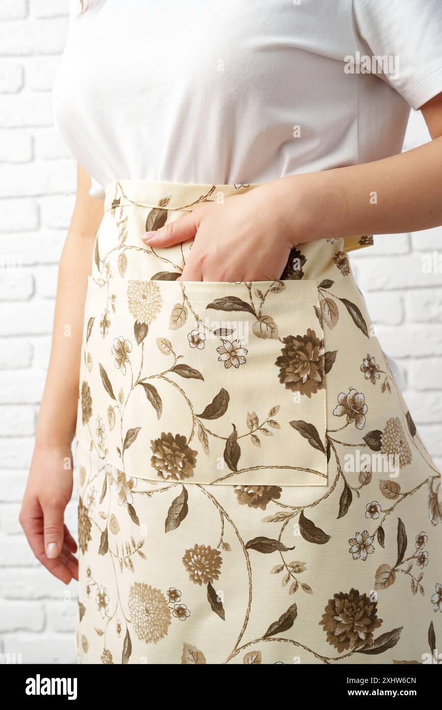Woman Wearing a Floral Print Apron Close Up Stock Photo - Alamy