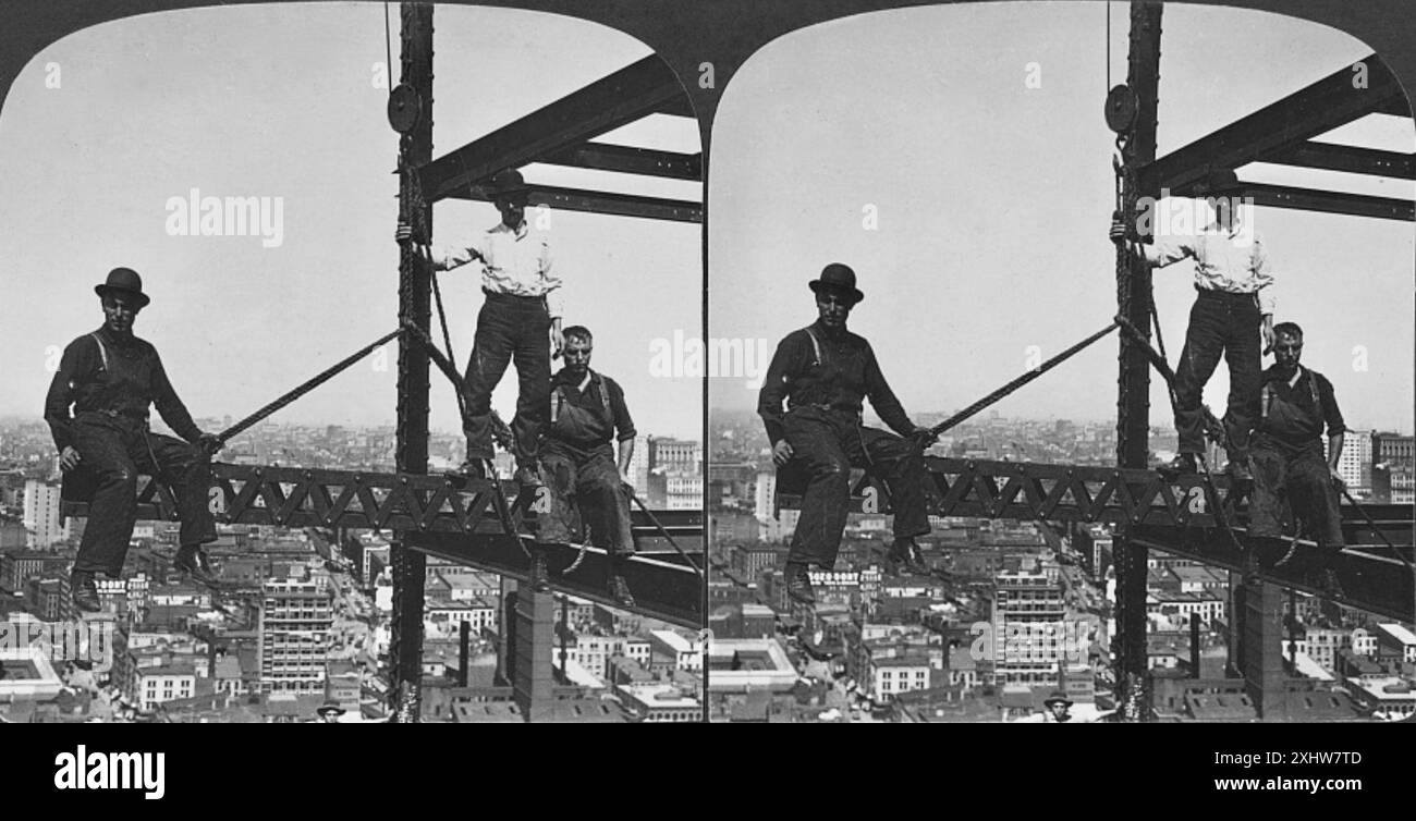 Agile construction workers on a suspended iron section, 200 feet above ...