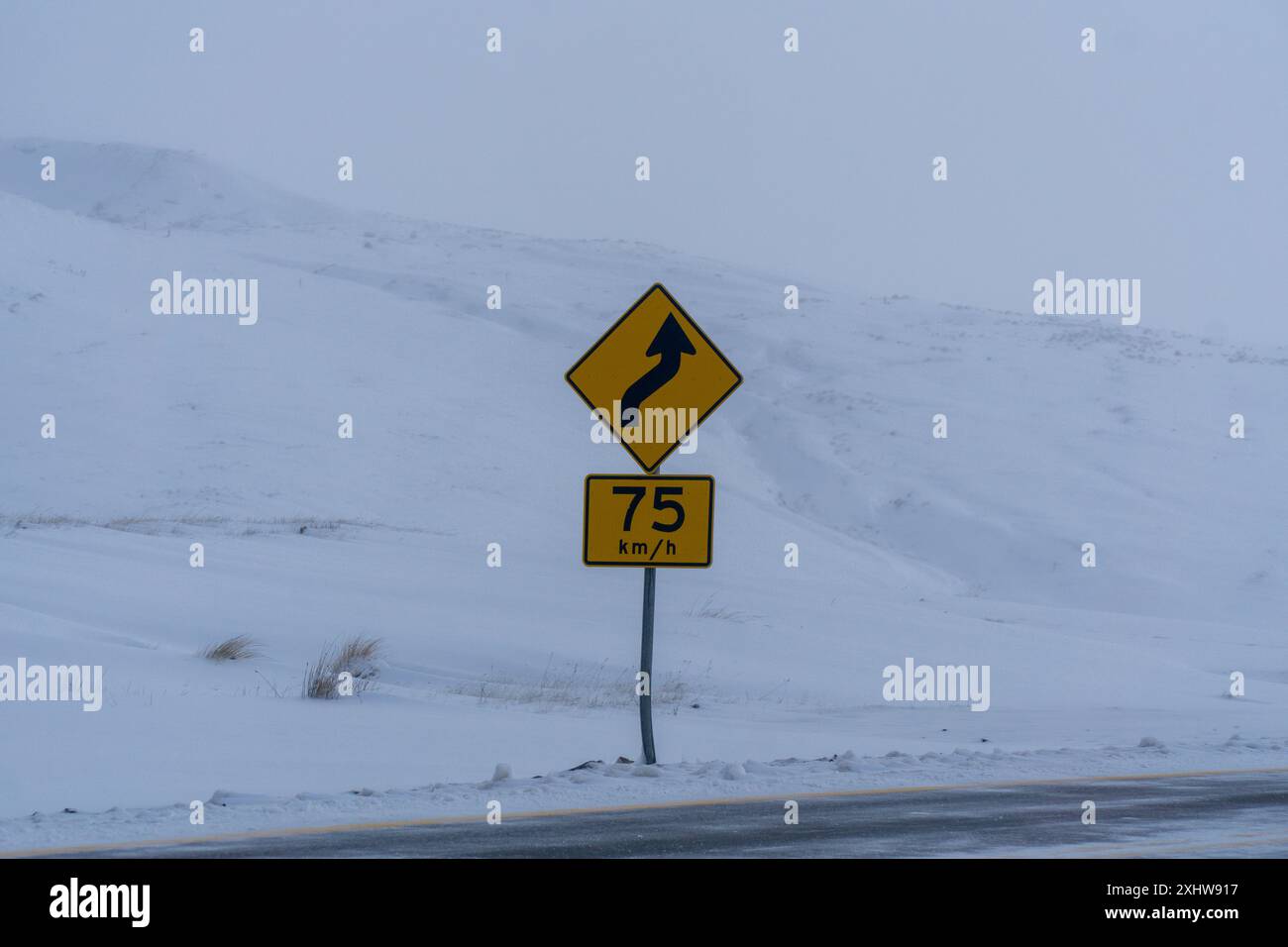 Yellow caution sign along the Snowy Mountains Highway in Kosciuszko ...