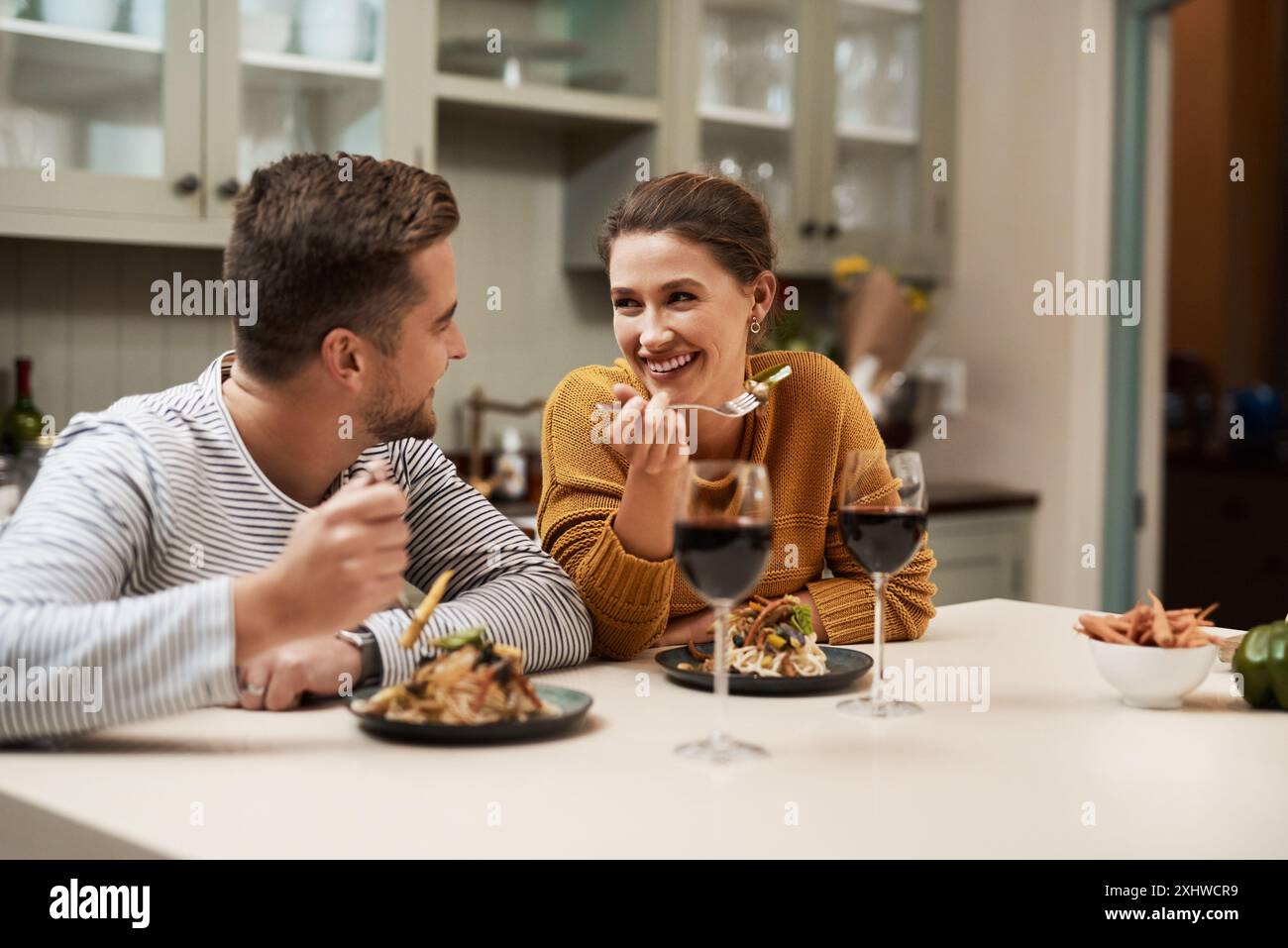 Smile, couple and eating food in home with wine on date night for ...