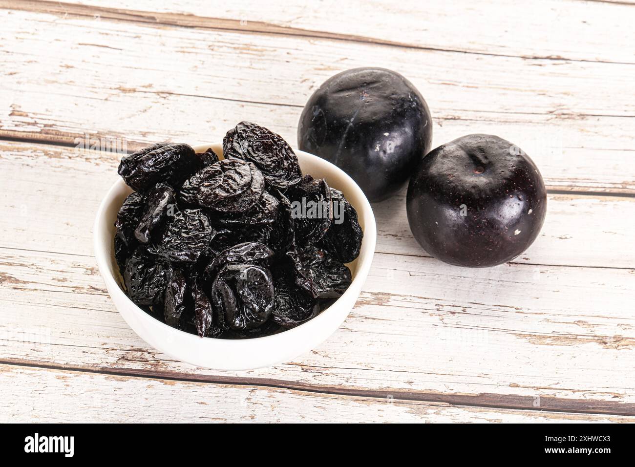 Dry sweet prunes in thw bowl Stock Photo - Alamy