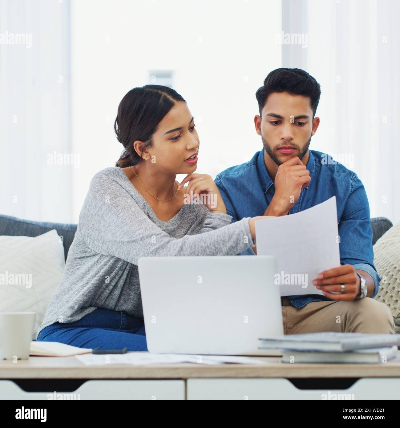Documents, laptop and planning with couple on sofa in living room of ...