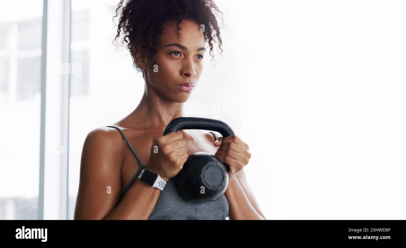 African woman, kettlebell and exercise at gym with strength in workout ...