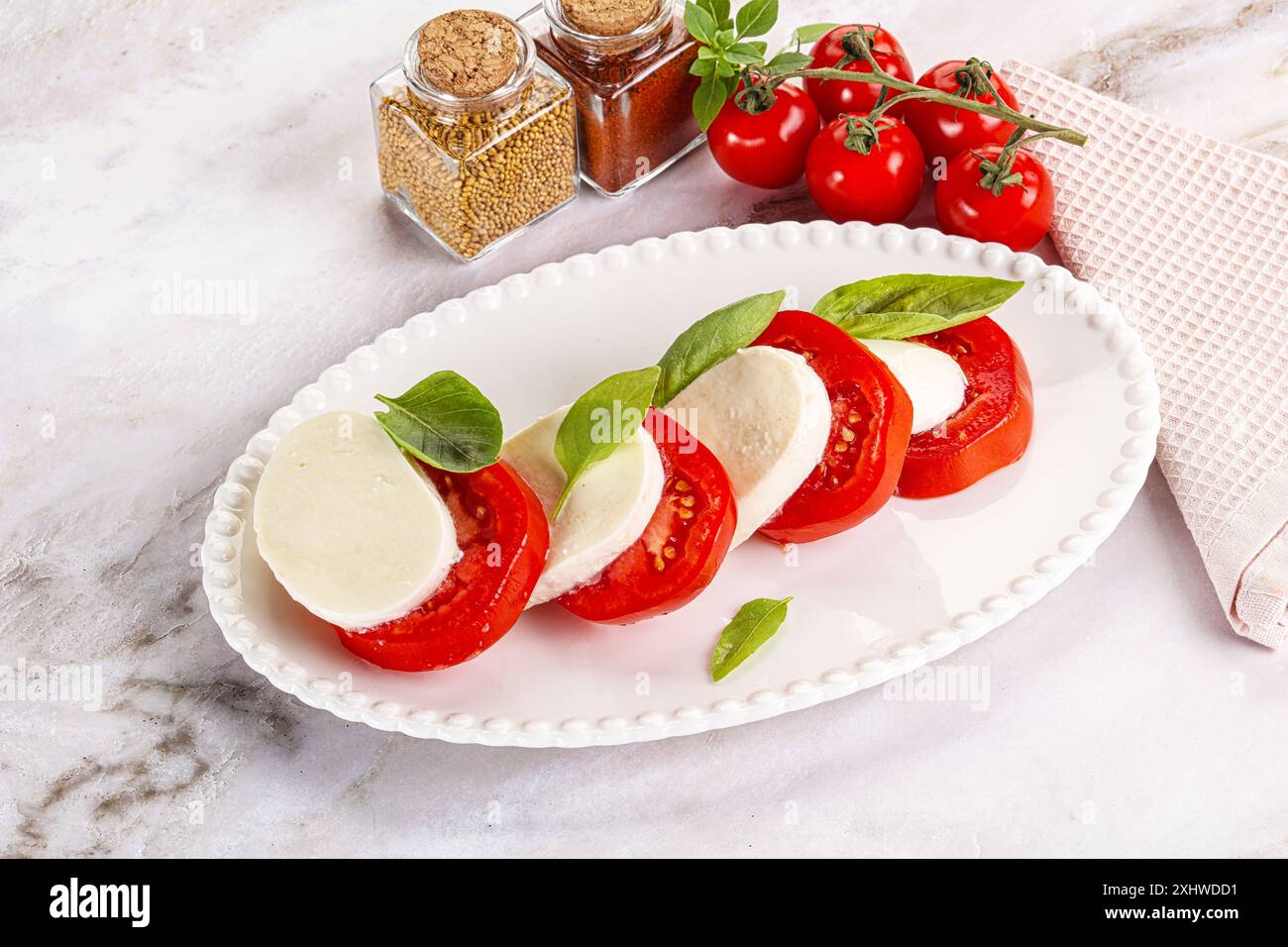 Italian caprese salad with mozzarella, tomato and basil Stock Photo - Alamy