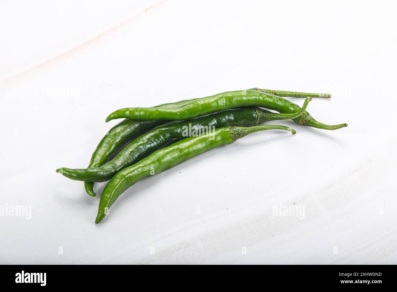 Hot and spicy green chili pepper heap Stock Photo - Alamy