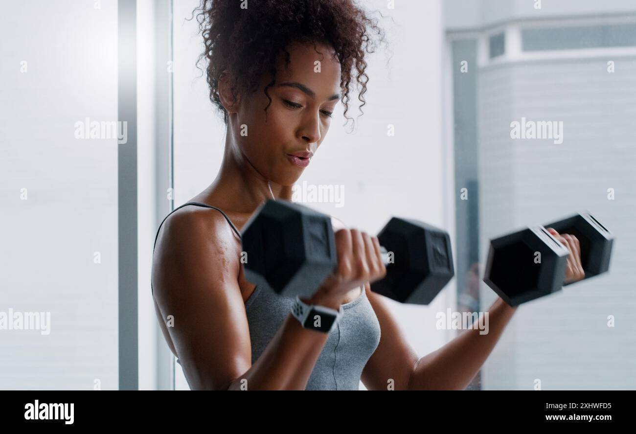 African woman, dumbbells and exercise at gym with breathing for workout ...