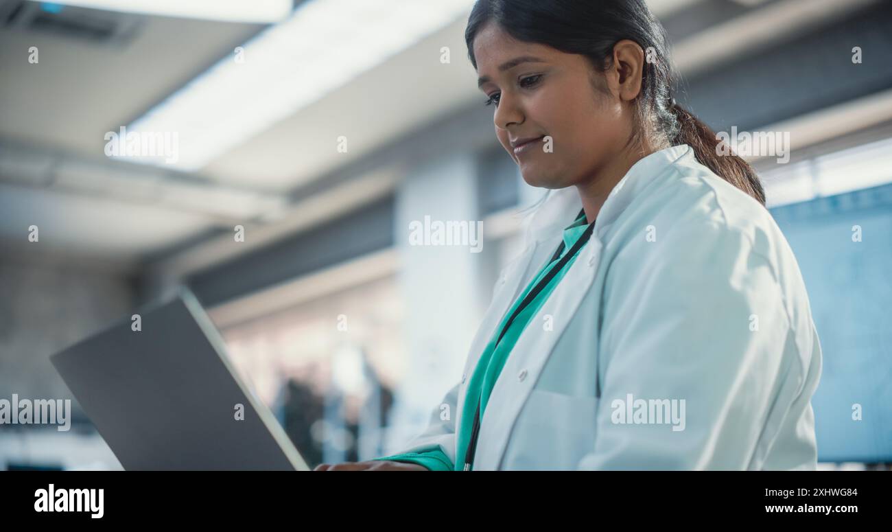 Young Indian Female Engineer Testing Futuristic Programmable Robot ...