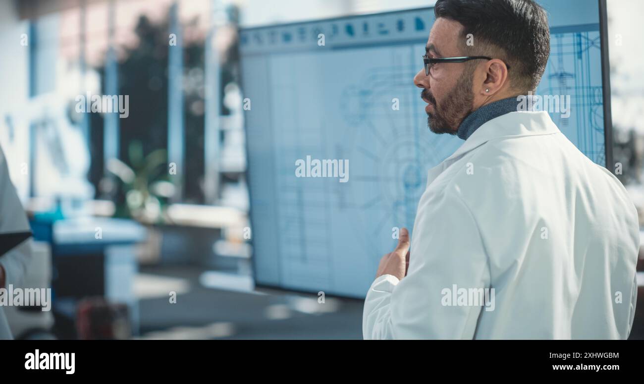 Senior Robotics Engineer Giving Presentation in front Of Television Set ...