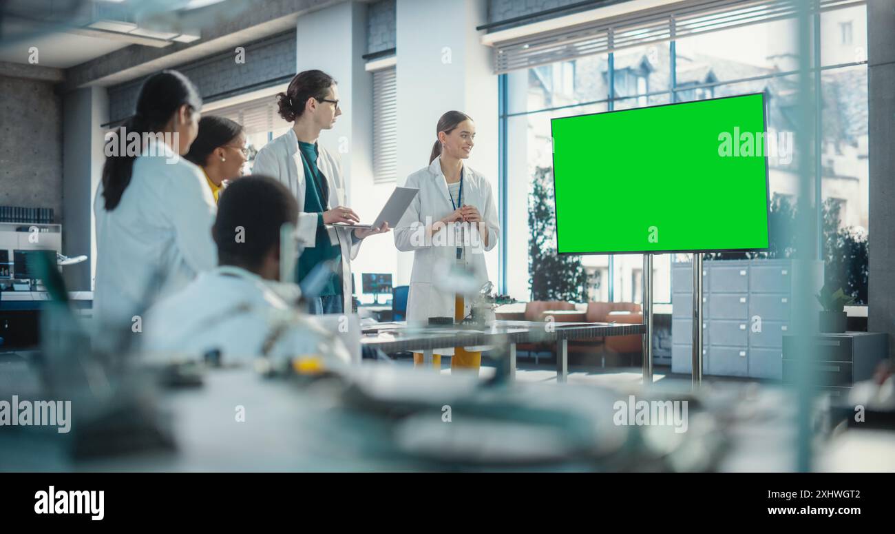 Group of Students Listening to Their Robotics Female Professor Who Uses ...