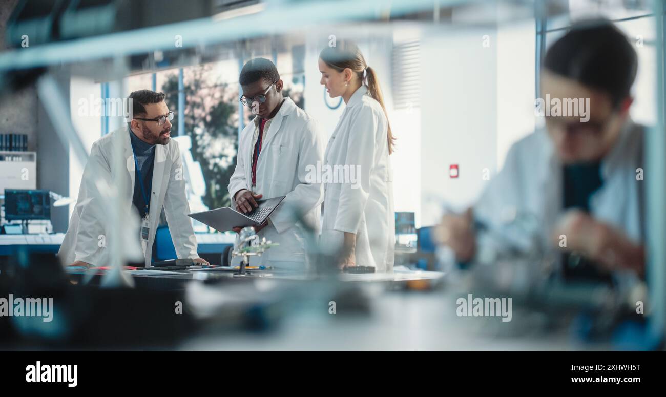 Multiethnic group engineers planning hi-res stock photography and ...