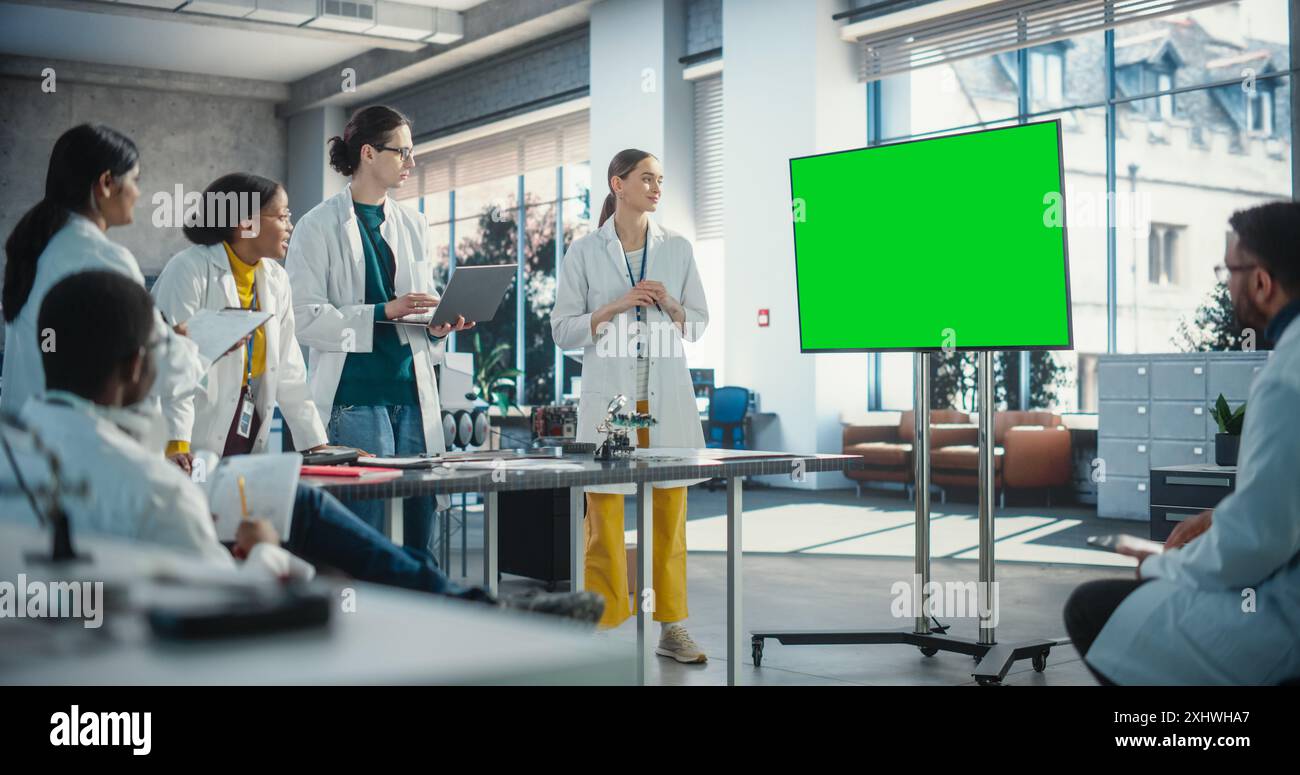Group of Students Listening to Their Robotics Female Professor Who Uses ...