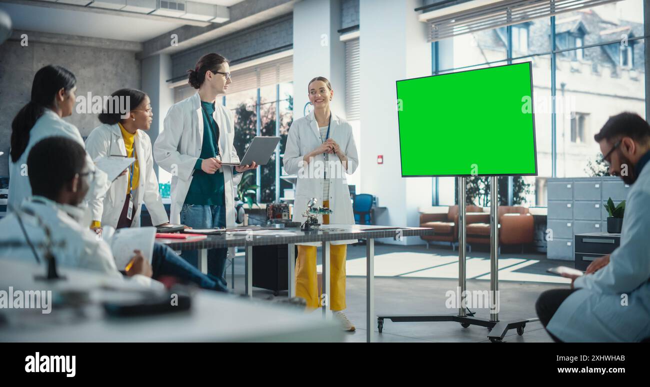 Group of Students Listening to Their Robotics Female Professor Who Uses ...